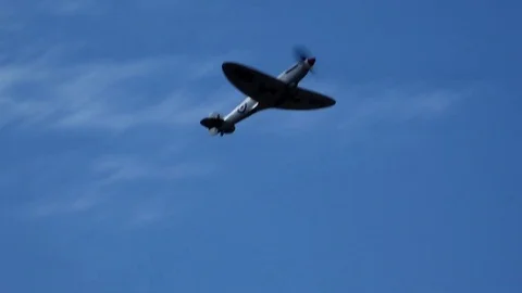 Spitfire flypast in blue sky 4k | Stock Video | Pond5
