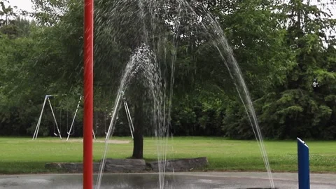Splash pad and swings in a public park w... | Stock Video | Pond5