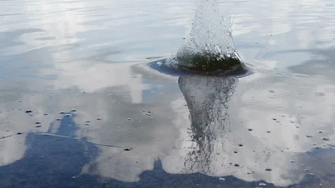 splash of water after throw stone | Stock Video | Pond5