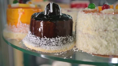 Sponge cakes on a rotating glass display... | Stock Video | Pond5