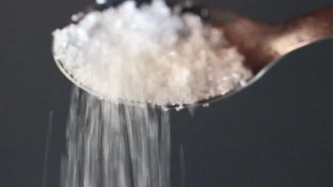 A spoon of sugar. Sugar falling from sp... | Stock Video | Pond5
