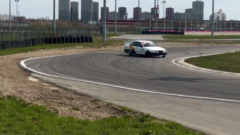 A sports car goes through a turn in a sl... | Stock Video | Pond5