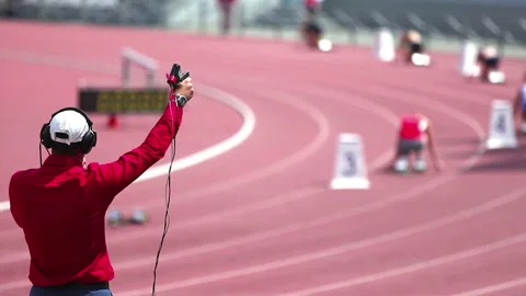 Sports judge shoots a starting pistol in... | Stock Video | Pond5