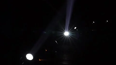 Spotlight machines create light beams wi... | Stock Video | Pond5