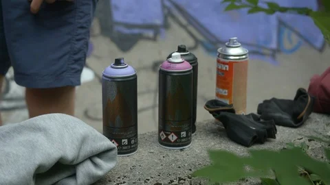 Spray paint cans on a ledge with graffit... | Stock Video | Pond5