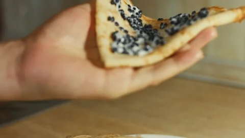 Spreading lump fish black roe with taram... | Stock Video | Pond5