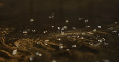 Sprinkle glass material on black backgro... | Stock Video | Pond5