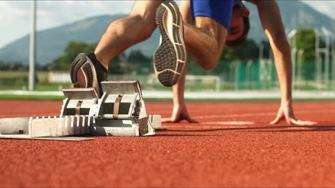 Sprinter assuming a start position in th... | Stock Video | Pond5