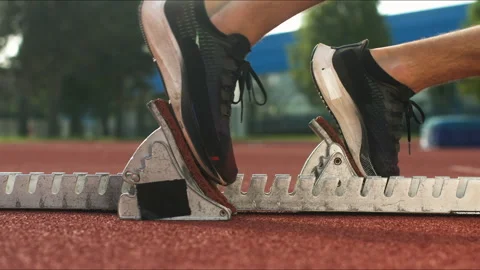 Sprinter legs in a crouching position in... | Stock Video | Pond5