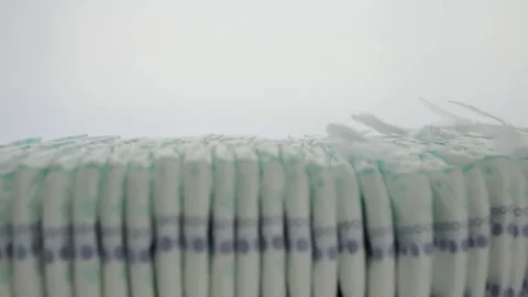Stack of baby diapers with light feather... | Stock Video | Pond5