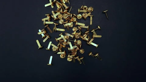 A stack of golden brass fasteners on a b... | Stock Video | Pond5