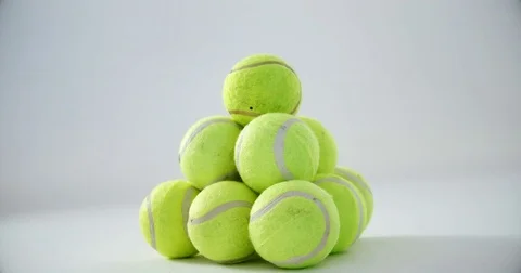 Stack of tennis balls on white backgroun... | Stock Video | Pond5