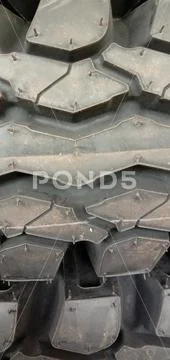 Photograph: Stack of truck tires with worm pattern #255478422