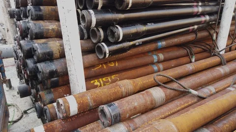Stack of used drill pipe for oil and gas... | Stock Video | Pond5