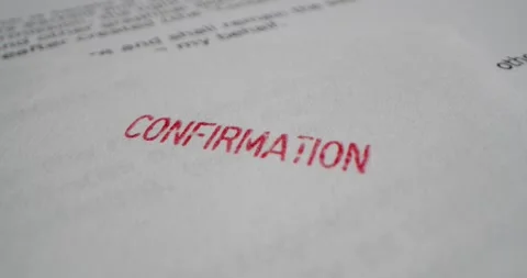 A stamp CONFIRMATION is placed on a shee... | Stock Video | Pond5