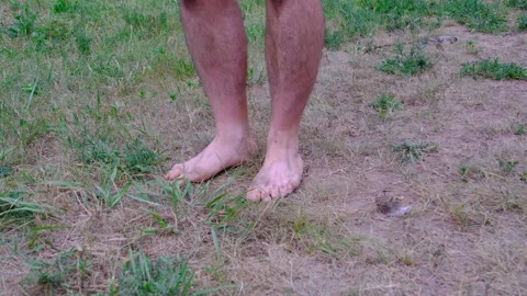Standing barefoot in the backyard with a... | Stock Video | Pond5