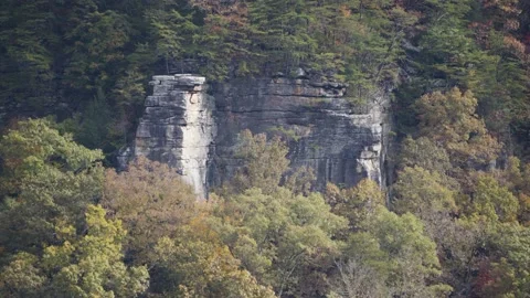 Static shot of a large cliff face surrou... | Stock Video | Pond5