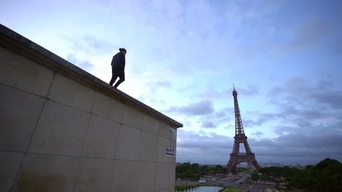 Static shot of a man walking on a roofto... | Stock Video | Pond5