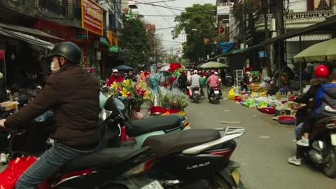 Static shot of moped riders riding throu... | Stock Video | Pond5