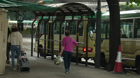 Static shot of people walking to the bus... | Stock Video | Pond5