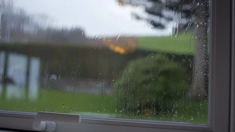 Static shot of rain hitting a window see... | Stock Video | Pond5