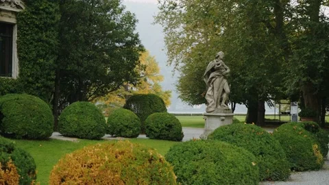Statue of human in park among trees and ... | Stock Video | Pond5