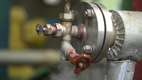 Steam and water leaking from pipes cause... | Stock Video | Pond5