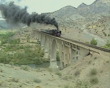 Steam train going over bridge approachin... | Stock Video | Pond5