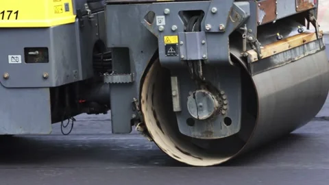 Steamroller wheels flattening fresh conc... | Stock Video | Pond5