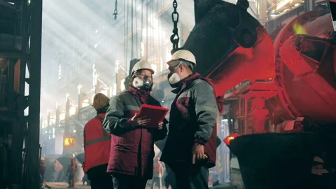 Steel mill workers are talking while wea... | Stock Video | Pond5
