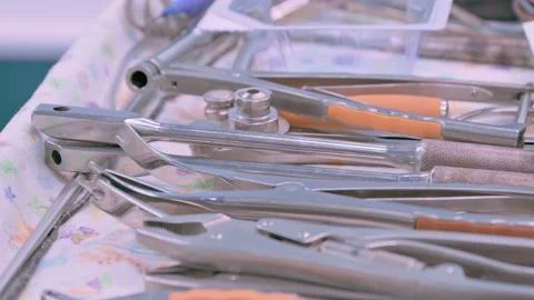Steel sterile surgical tools lying on ta... | Stock Video | Pond5