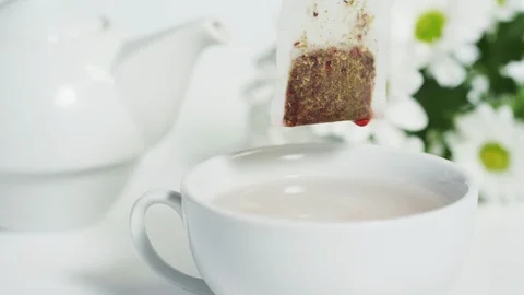Steeping a tea bag into the water | Stock Video | Pond5