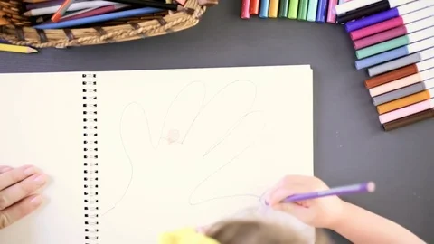 Step by step. Little girl tracing her ha... | Stock Video | Pond5