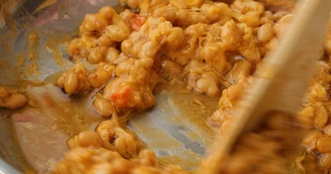 Stirring maple syrup into baked beans wi... | Stock Video | Pond5