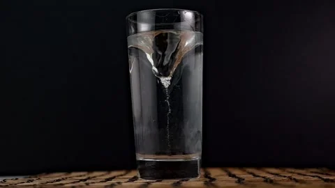 Stirring a teaspoon of crystal clear wat... | Stock Video | Pond5