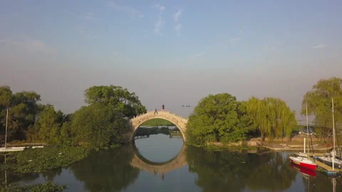 Stone arch bridge forms circle reflected... | Stock Video | Pond5