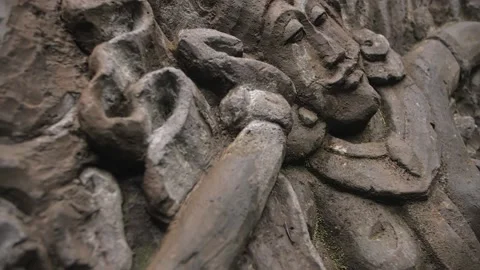 stone-carved statues of human faces and ... | Stock Video | Pond5