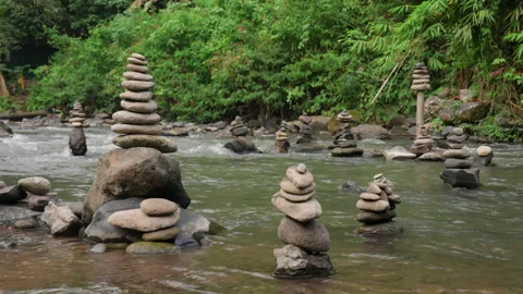 Stone towers on river rocks in summer fo... | Stock Video | Pond5