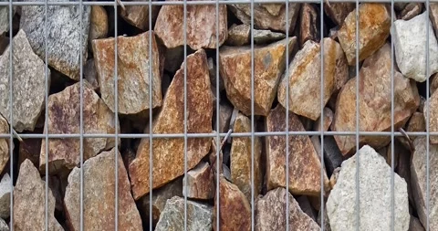 Stones of various sizes in the wire mesh... | Stock Video | Pond5