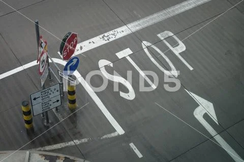 Stop and other notice safety signs on the airport terminal road ...