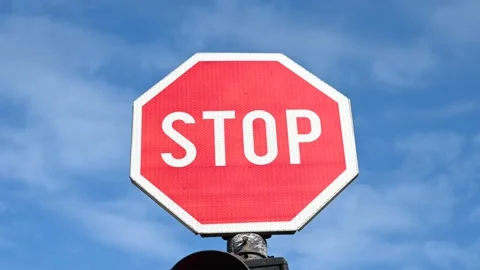 Stop sign and red light at a traffic lig... | Stock Video | Pond5