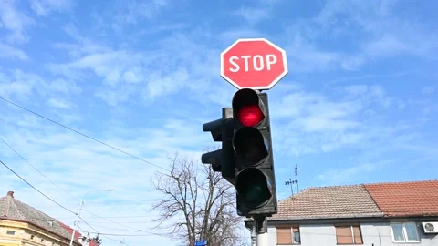 Stop sign and traffic light at an inters... | Stock Video | Pond5