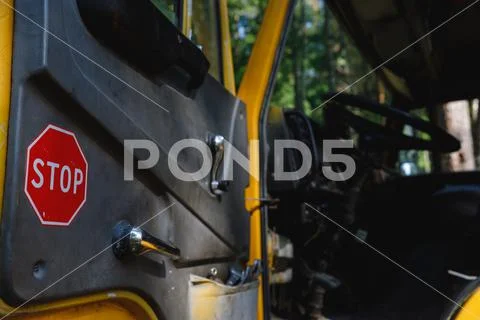 Photograph: Stop sign on the car door. truck cab overlooking the ...