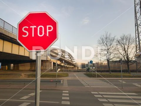 Stop sign in front of road crossing ~ Premium Photo #104213224