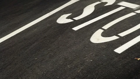 STOP written with paint on asphalt befor... | Stock Video | Pond5