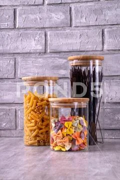Photograph: Storing pasta of three types in glass jars #236313252