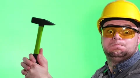A strange worker with a hammer in his ha... | Stock Video | Pond5