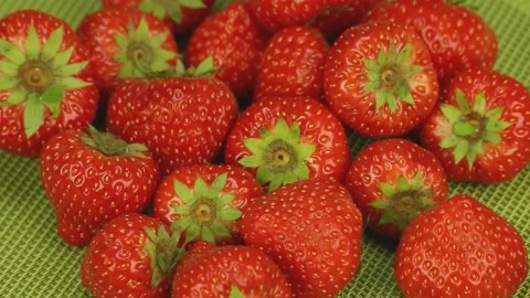 Strawberry rotate on a green background | Stock Video | Pond5