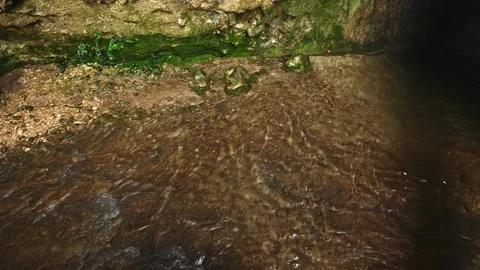 A stream of flowing river water, forming... | Stock Video | Pond5
