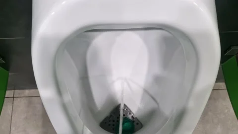 a stream of urine in a toilet bowl. a ma... | Stock Video | Pond5